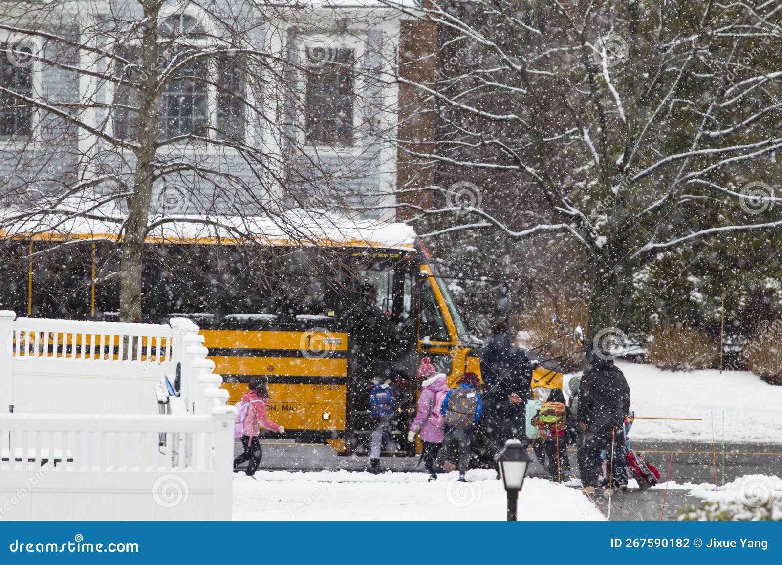 Elementary School Students Accompanied by Parents Boarding School Bus ...