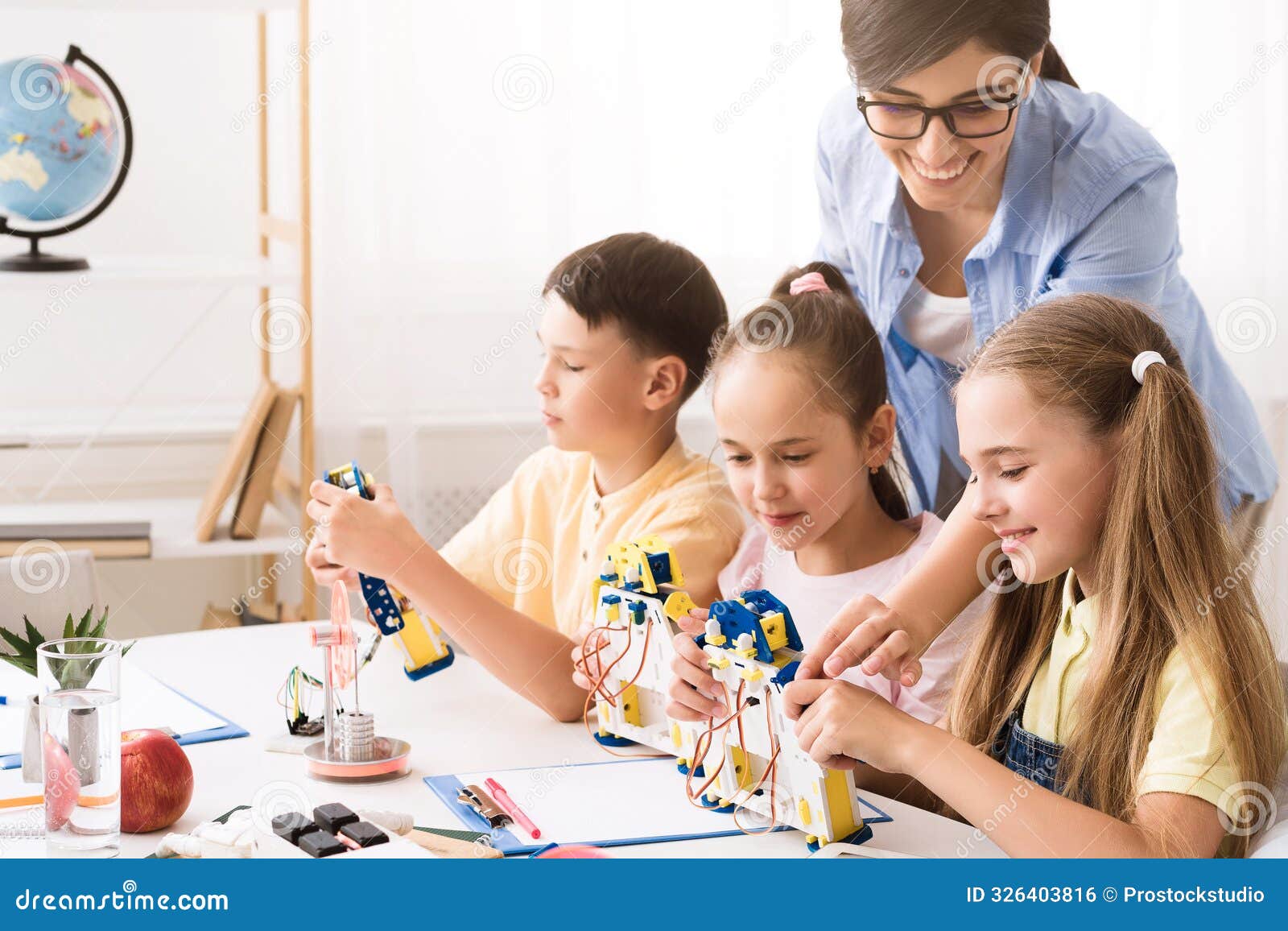 Elementary School Students Building Robots with Teacher Stock Photo ...
