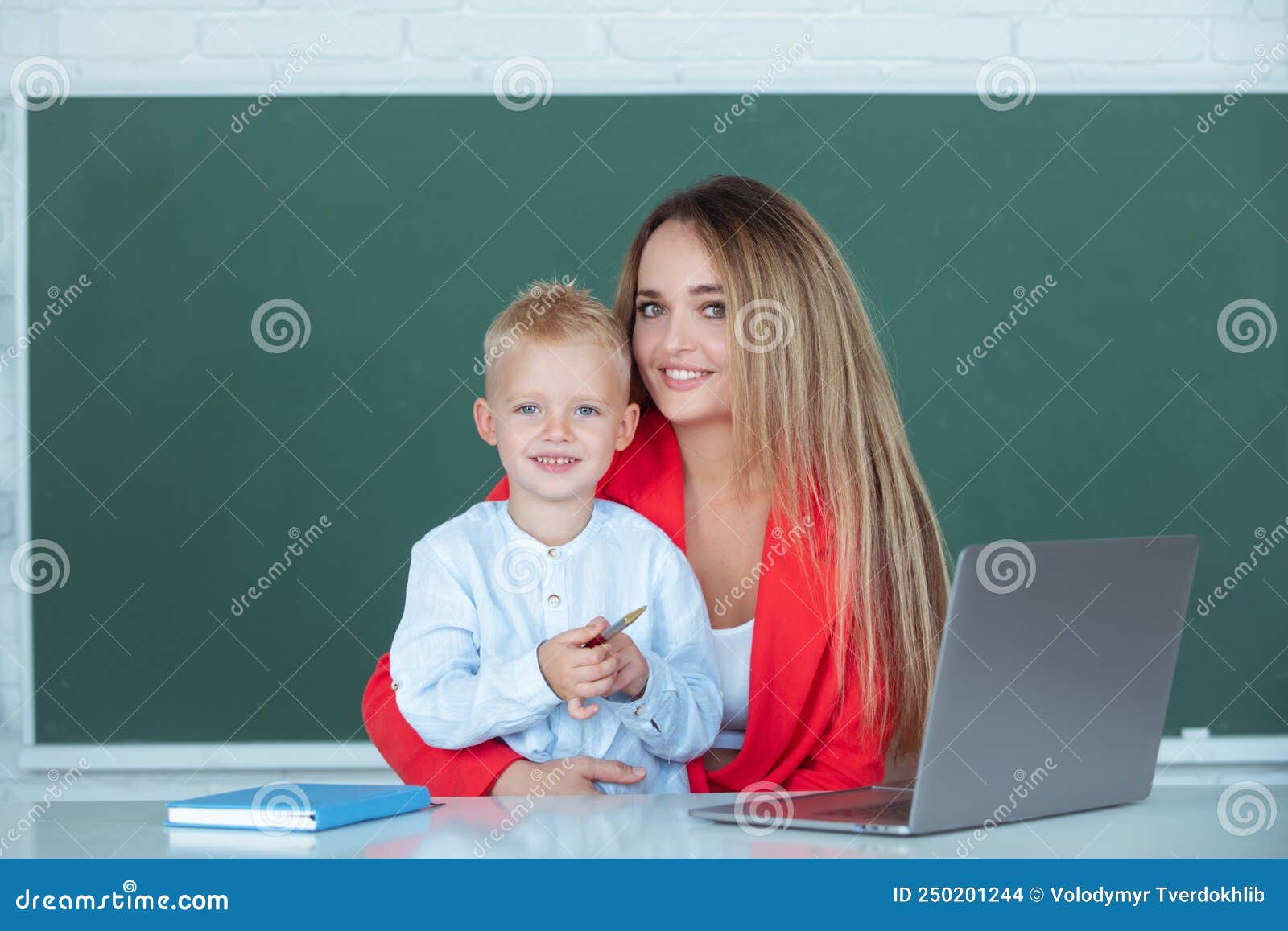 Elementary School Teacher and Pupil in Classroom. Mother and Son ...