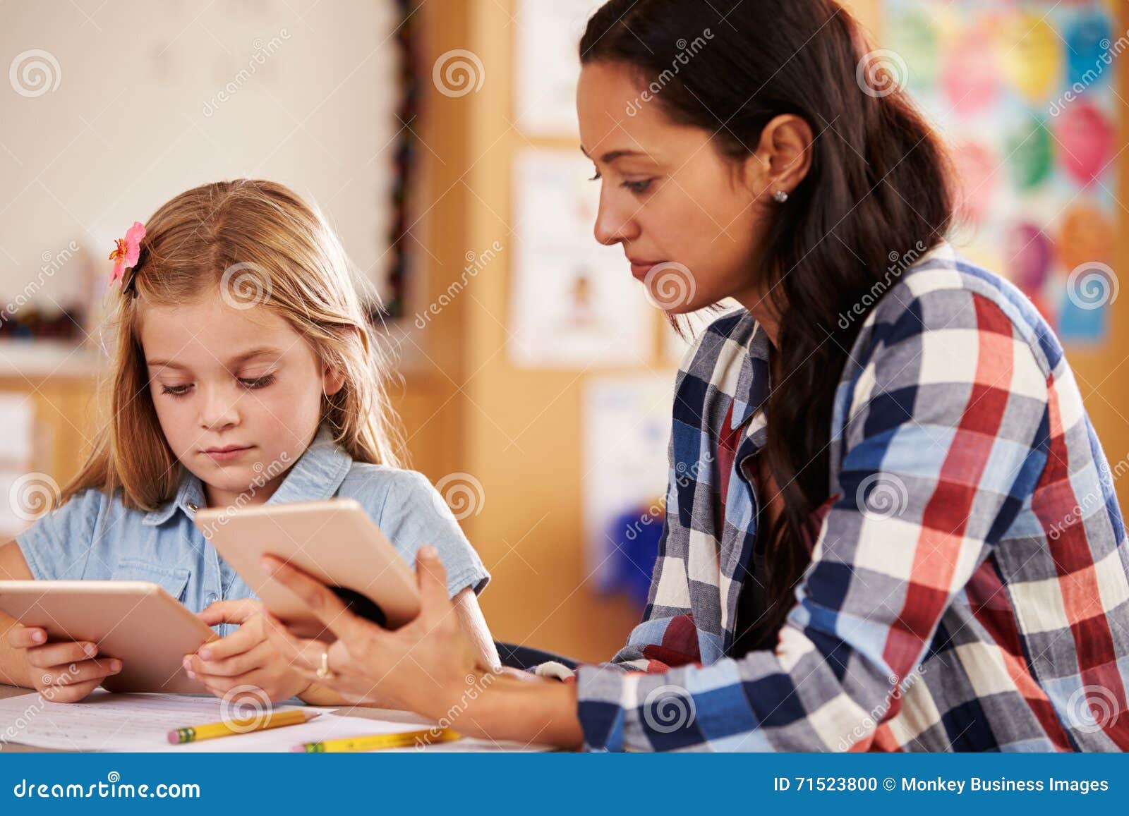 Elementary School Teacher and Pupil Using Tablet Computers Stock Photo ...