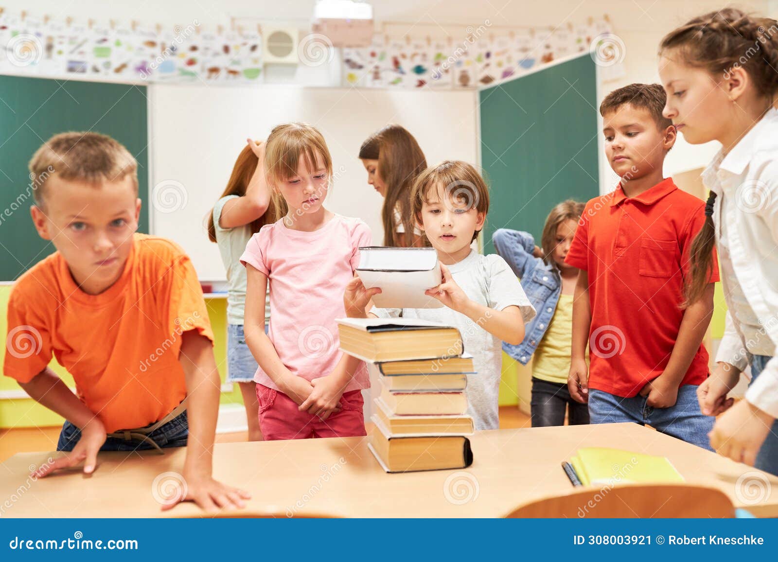 Students Stacking Books on Bench in Class Stock Image - Image of piling ...