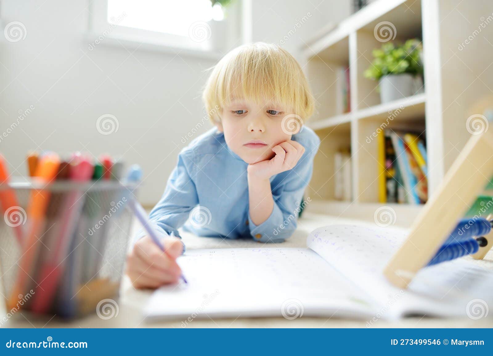 Elementary Student Boy Doing Homework on Floor at Home. Child Learning ...
