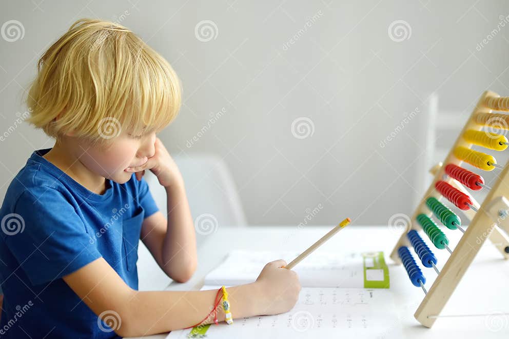 Elementary Student Boy Doing Homework at Home. Child Learning To Count ...