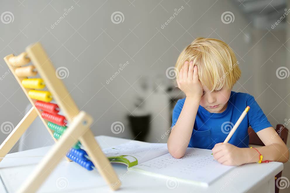 Elementary Student Boy Doing Homework at Home. Child Learning To Count ...
