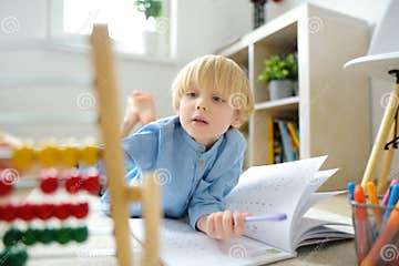 Elementary Student Boy Doing Homework at Home. Child Learning To Count ...