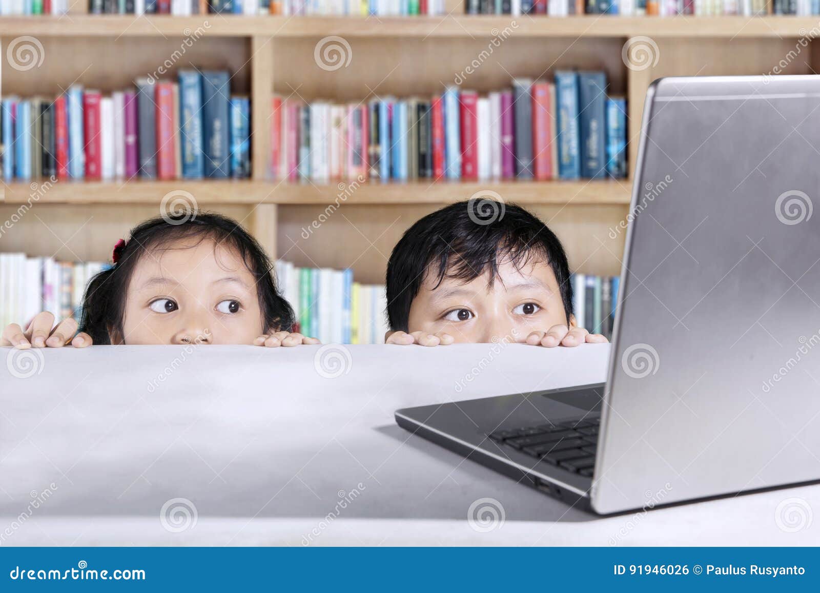 Elementary Students Peeping Laptop in Library Stock Photo - Image of ...