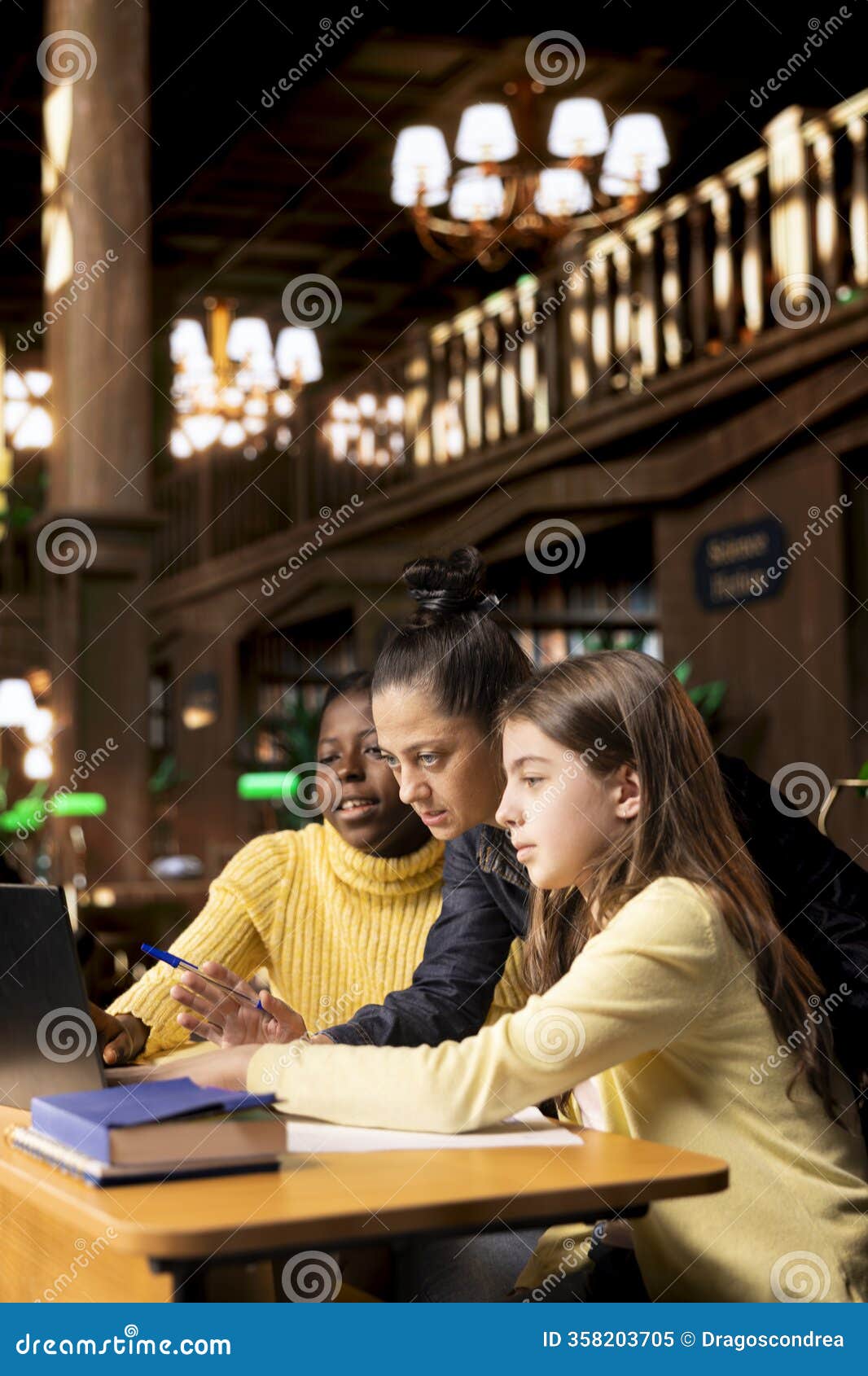 Elementary Students Receiving Support from Tutor Working on Homework ...