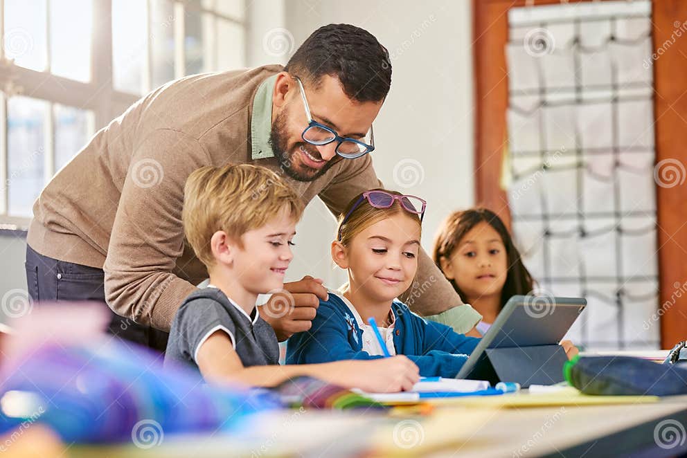 Elementary Students Working on Digital Tablet with the Help of the Teacher Stock Image - Image ...