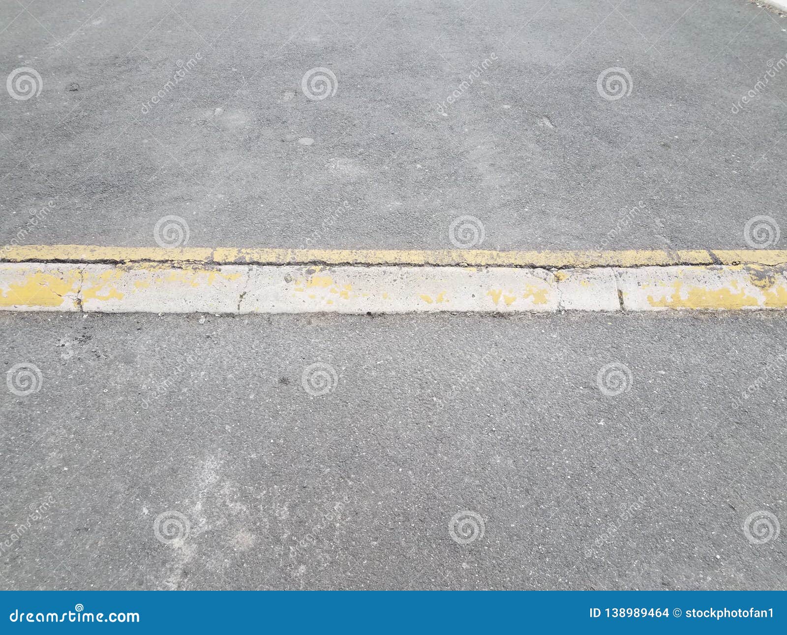 Elevated Asphalt or Pavement Path with Yellow Curb or Ramp Stock Photo ...