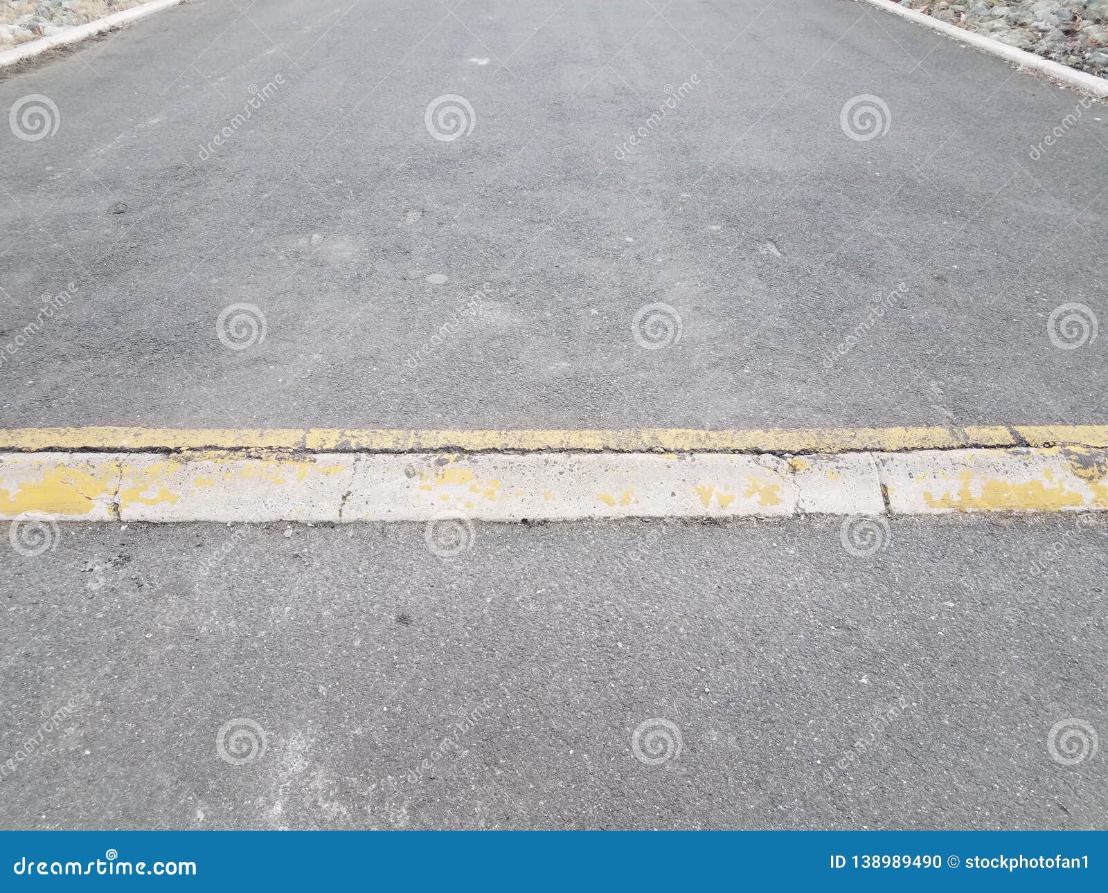 Elevated Asphalt or Pavement Path with Yellow Curb or Ramp Stock Photo ...
