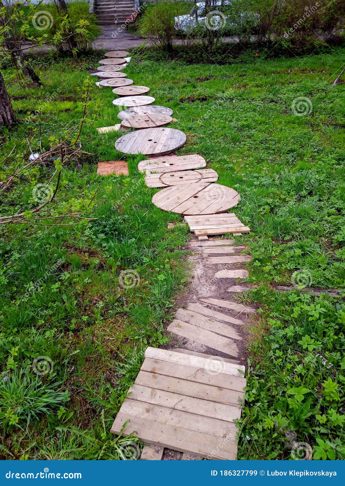 An Elevated Wooden Path Curves through a Green Lawn Stock Image - Image ...
