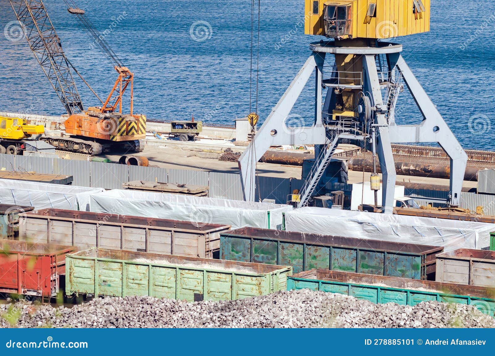 Elevating Port Crane and Railway Wagons in a Cargo Seaport Stock Image ...
