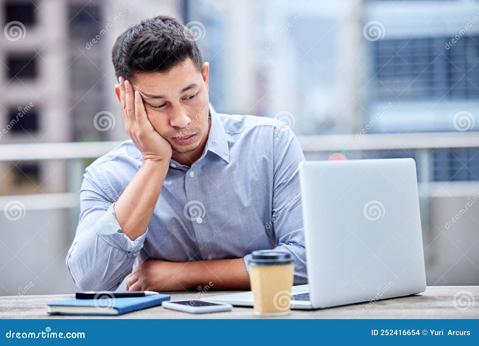 The Emails Just Keep Coming. a Young Businessman Looking Bored while ...