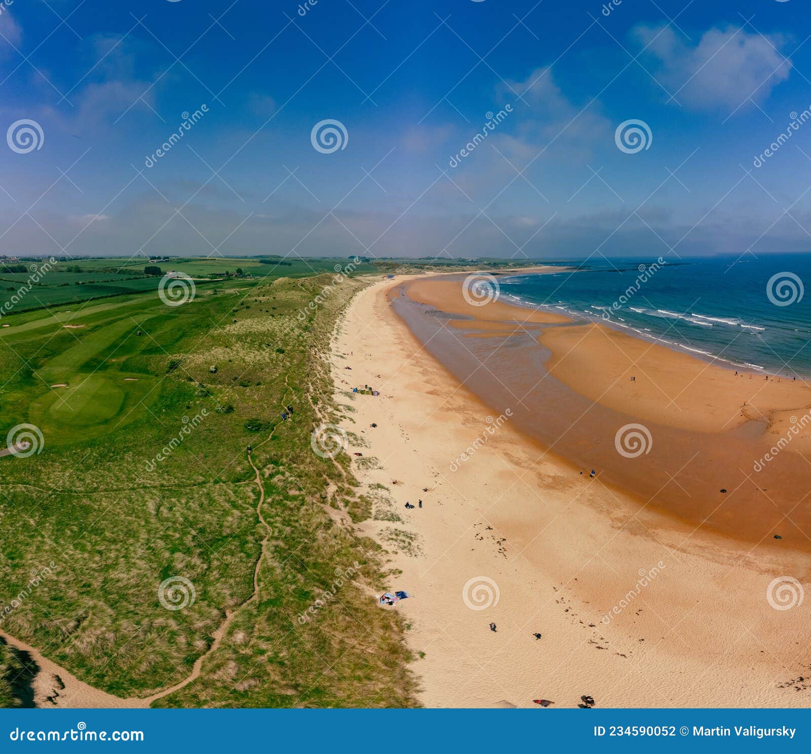 Embleton Bay and Burn Sandy Beach with the Ruins of Dunstanburgh Castle ...