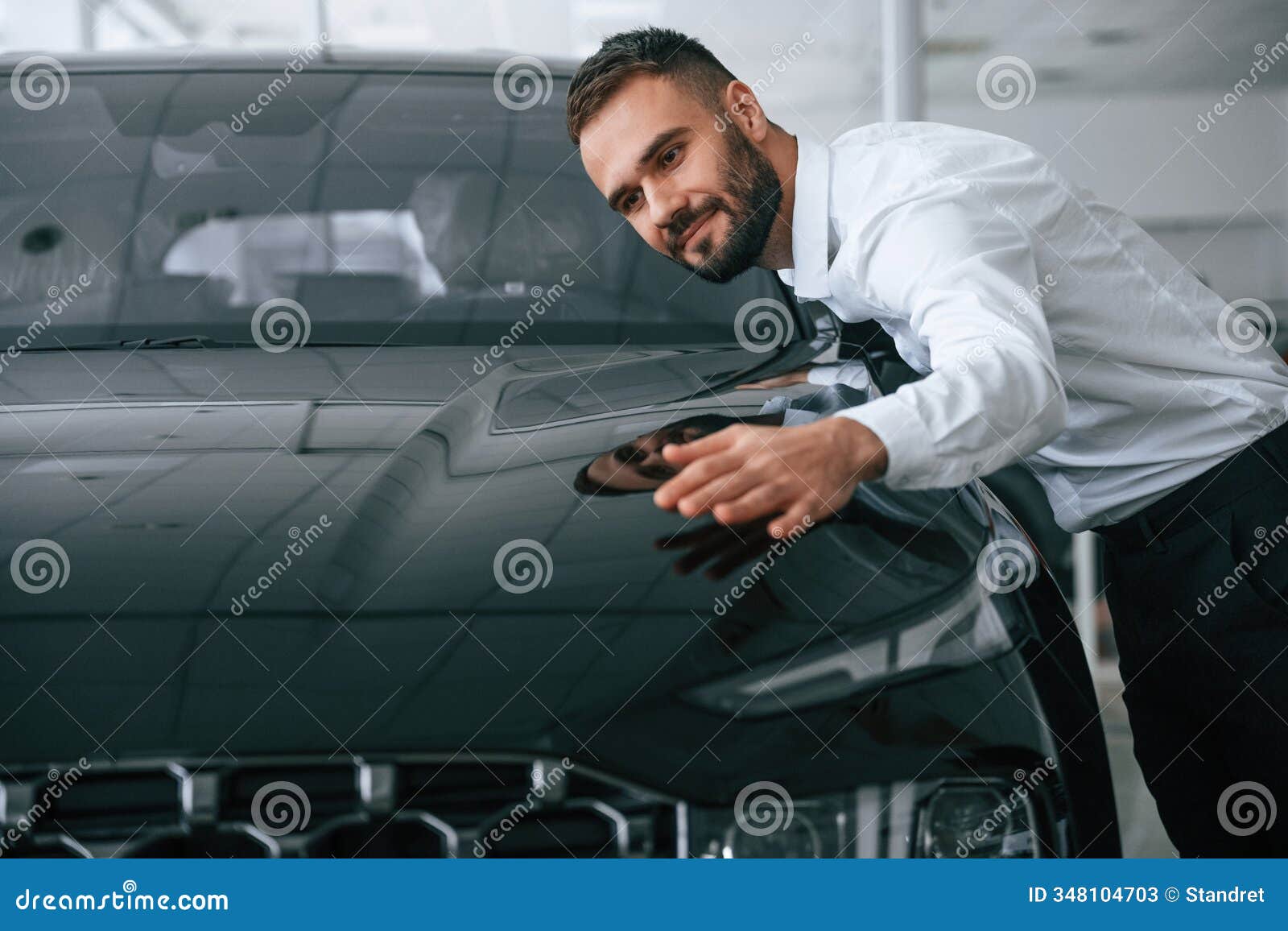 Embracing the Car. Worker in Formal Clothes is in the Auto Salon Stock ...