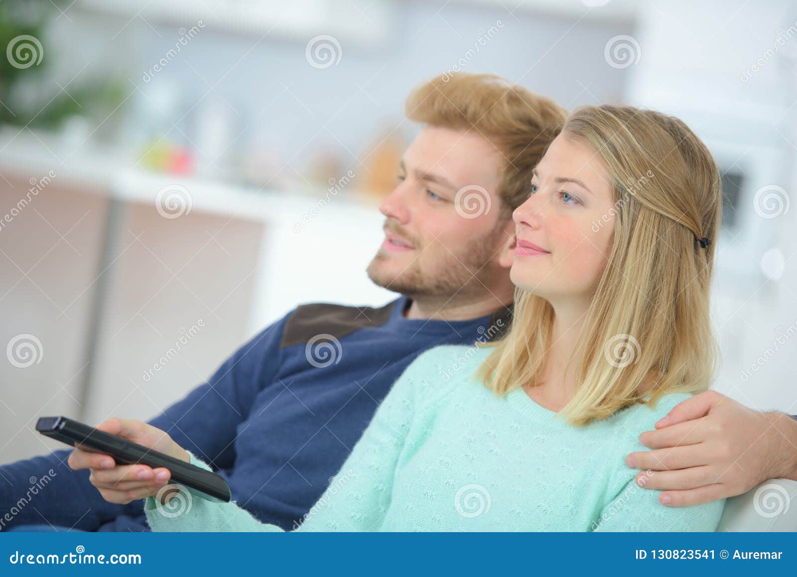Embracing Couple Using Remote Control Stock Image - Image of happy ...