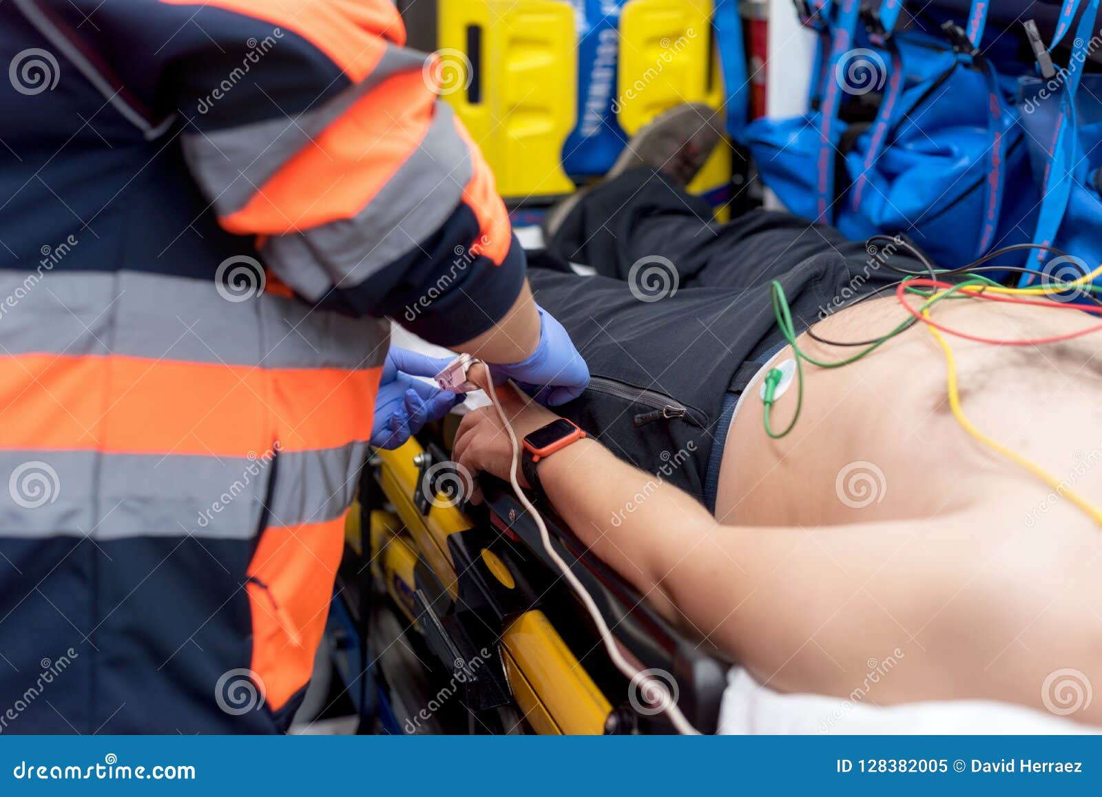 Emergency Doctor Checking Pulse of a Patient in the Ambulance Stock ...
