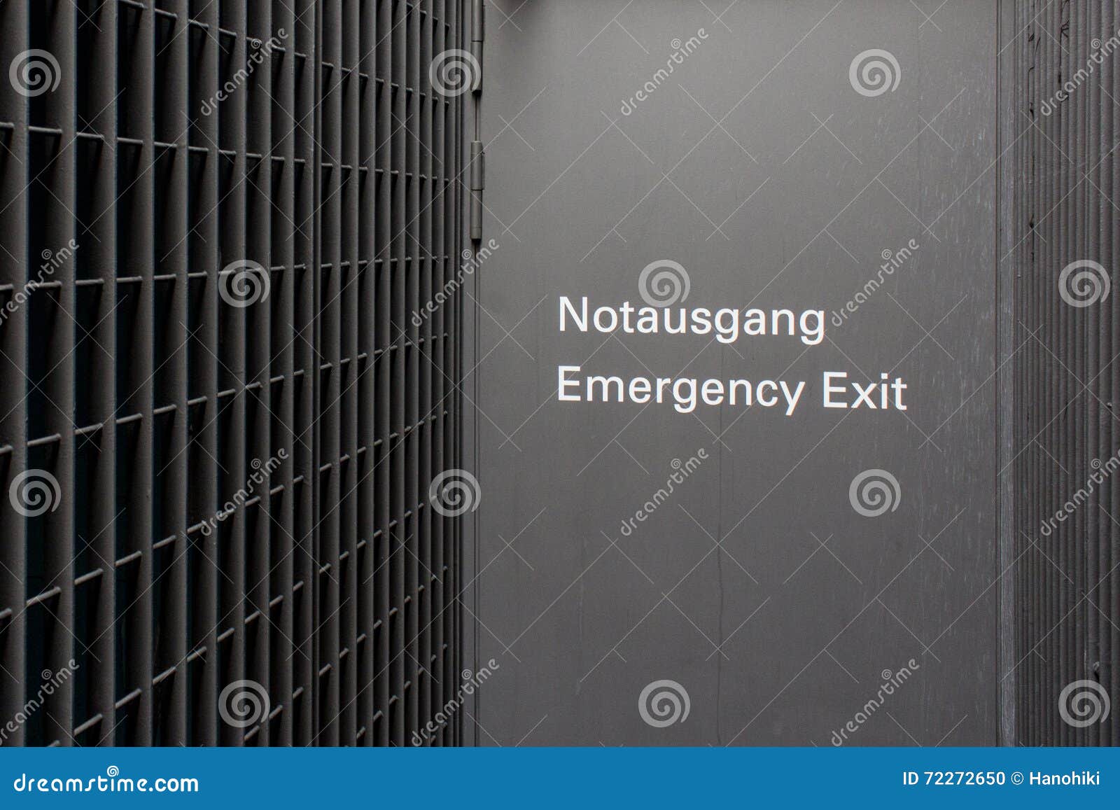 Emergency Exit Door, German and English Text on Grey Door Stock Photo ...