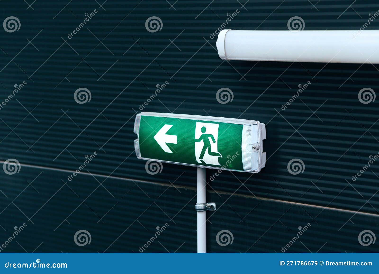 Emergency Exit Green Sign on Wall at Emergency Stairs at Shopping ...