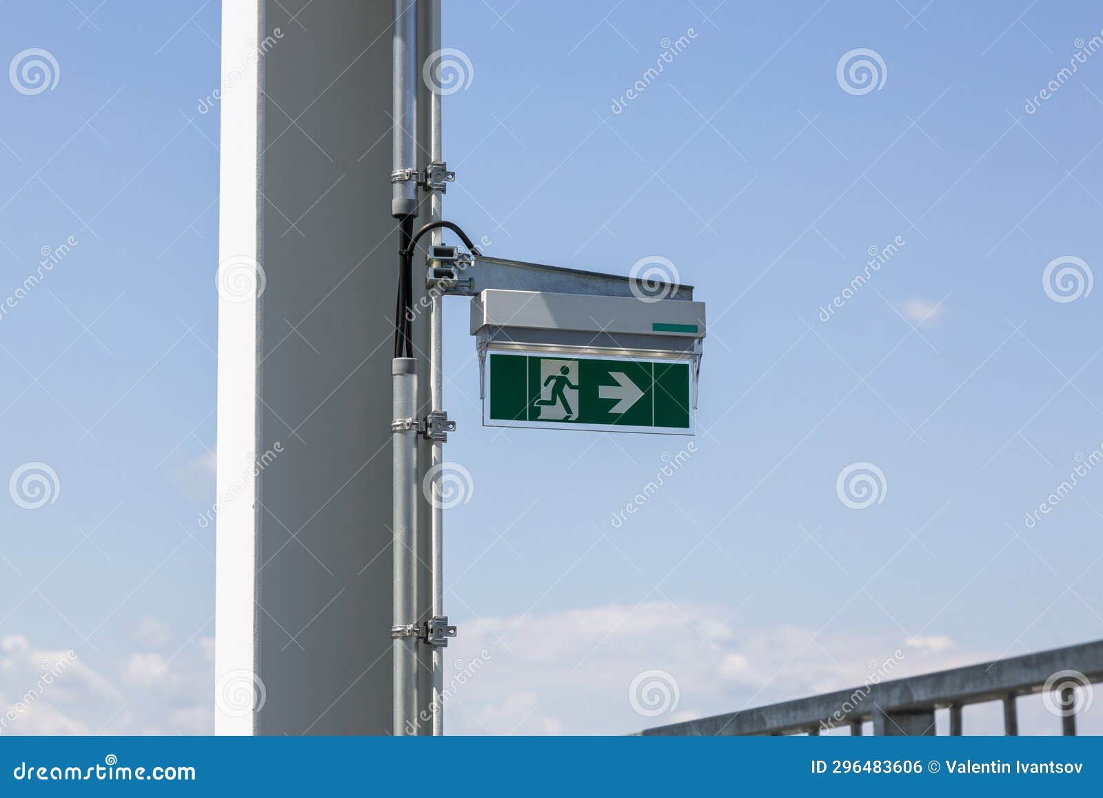 Emergency Exit Indicator on a Metal Pillar Stock Photo - Image of ...