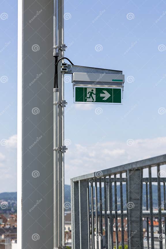 Emergency Exit Indicator on a Metal Pillar Stock Photo - Image of rules ...