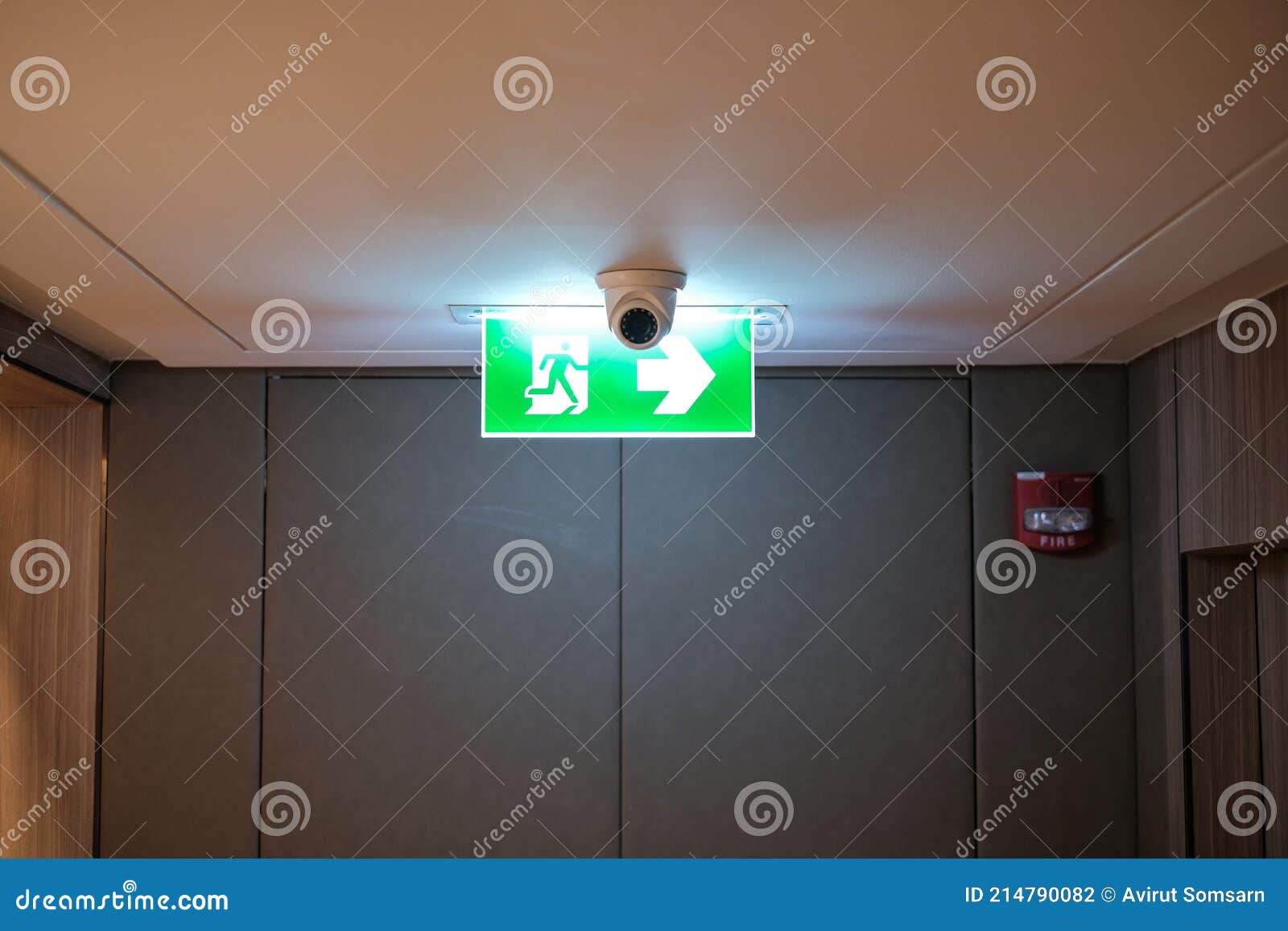 Emergency Exit Sign at the Corridor in Building. Green Fire Exit Sign ...
