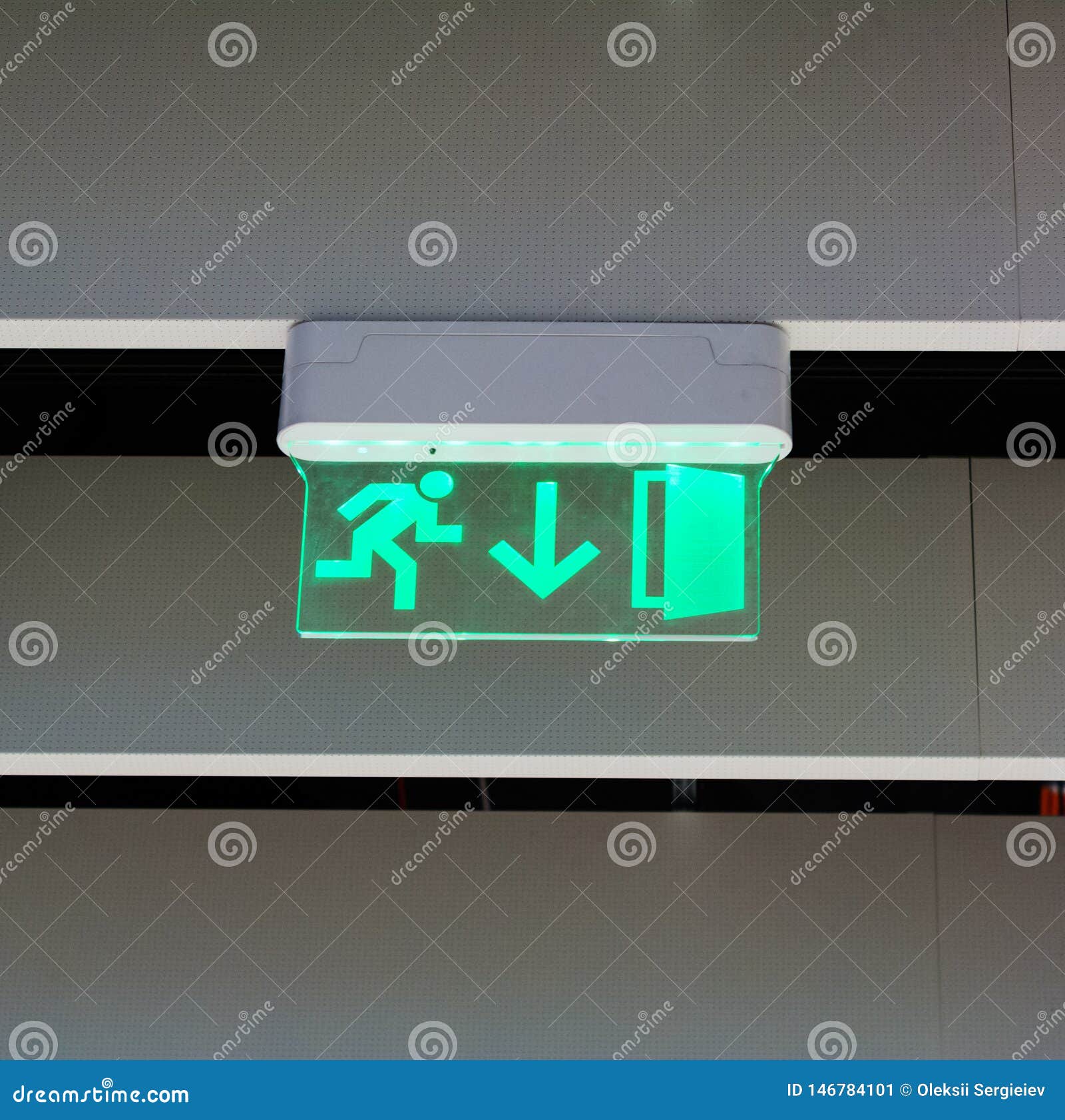 Glowing Emergency Exit Sign With Left Arrow At A Building. Safety First ...