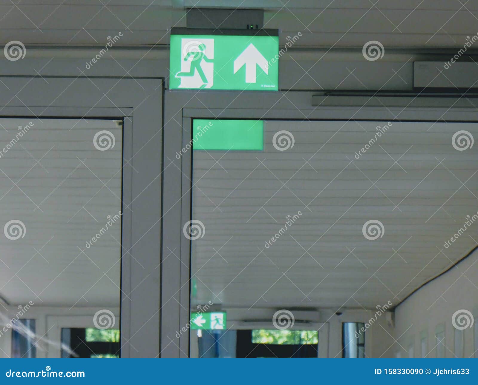 Emergency Exit Signs in Hallway of Building. Stock Photo - Image of ...