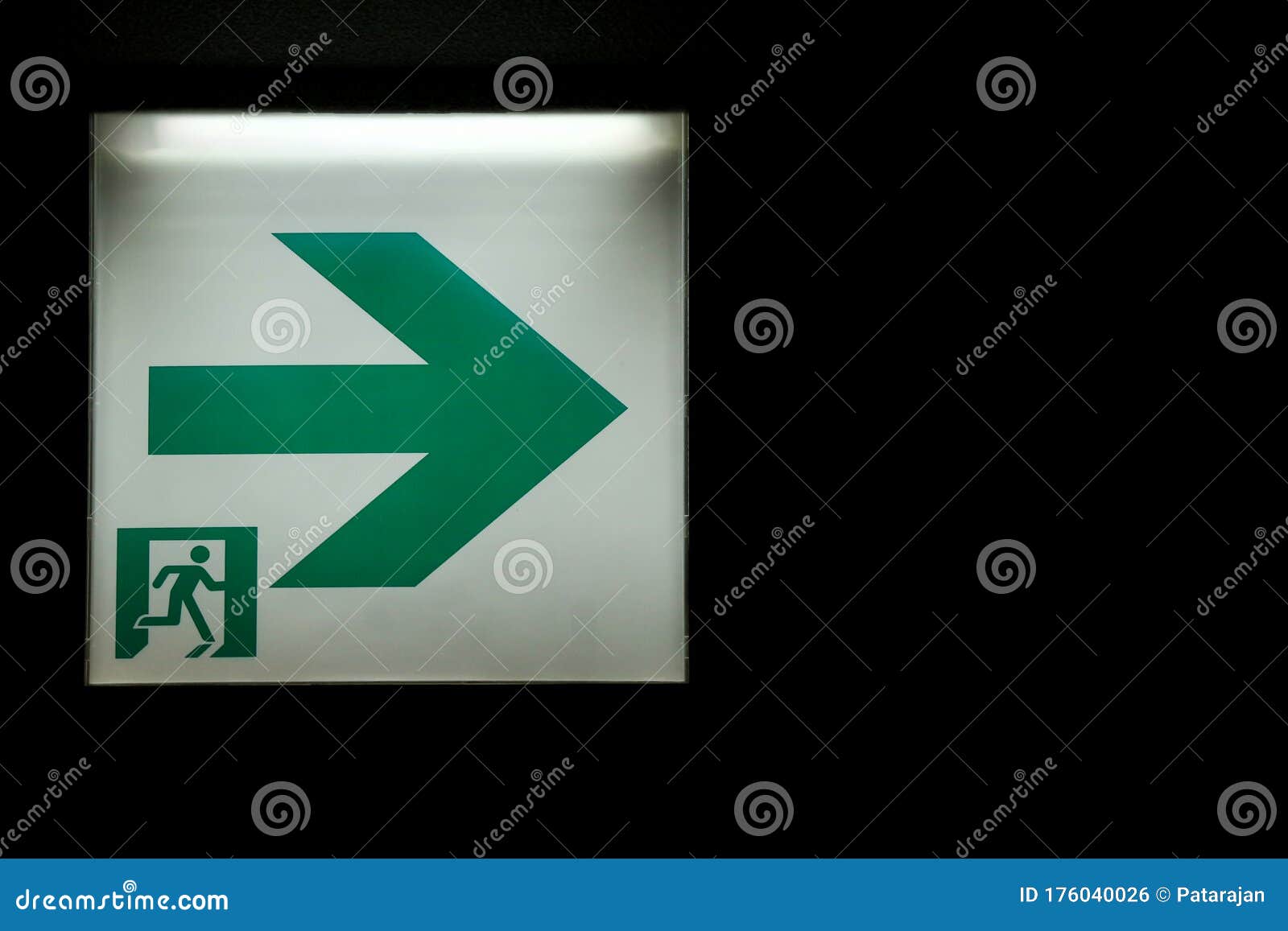 An Emergency Exit Way Sign Board on the Dark Room Wall Background Stock ...