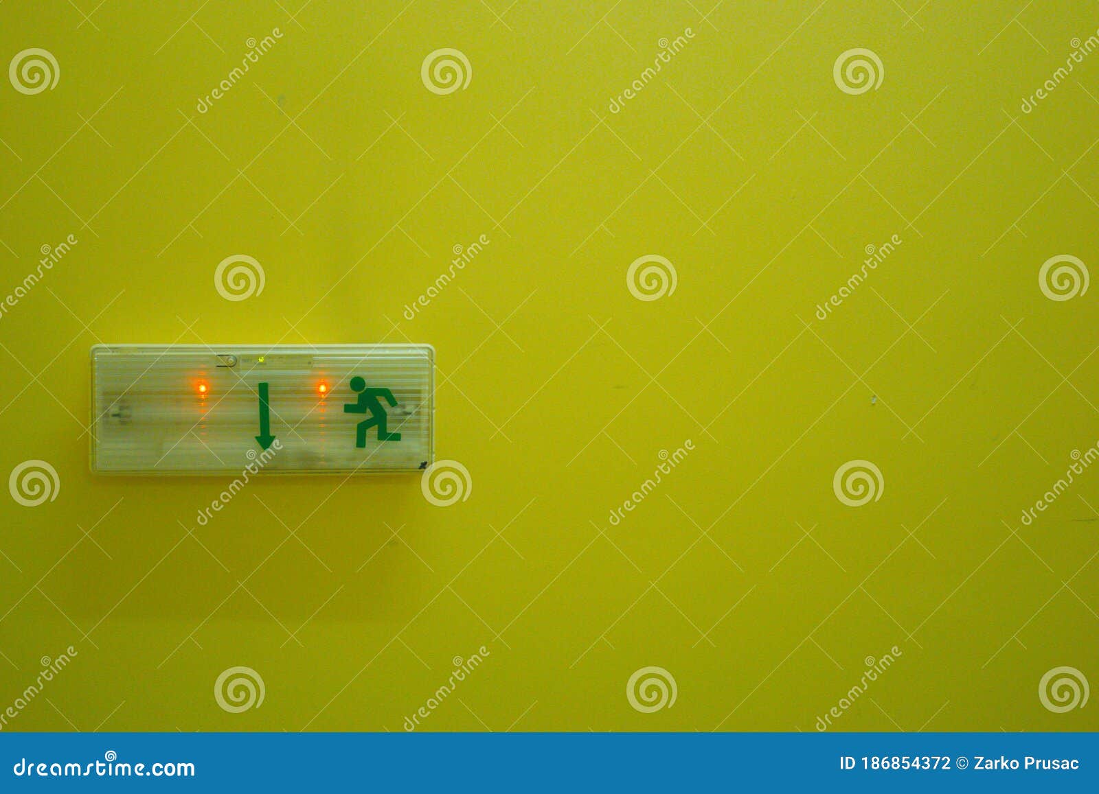 Emergency Exit on the Yellow Wall Stock Photo - Image of message, green ...
