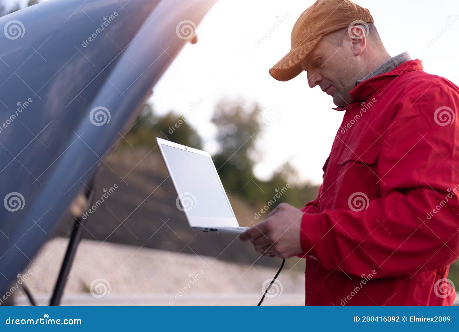 Emergency Roadside Assistance, Road Assistance Worker in Uniform Trying ...