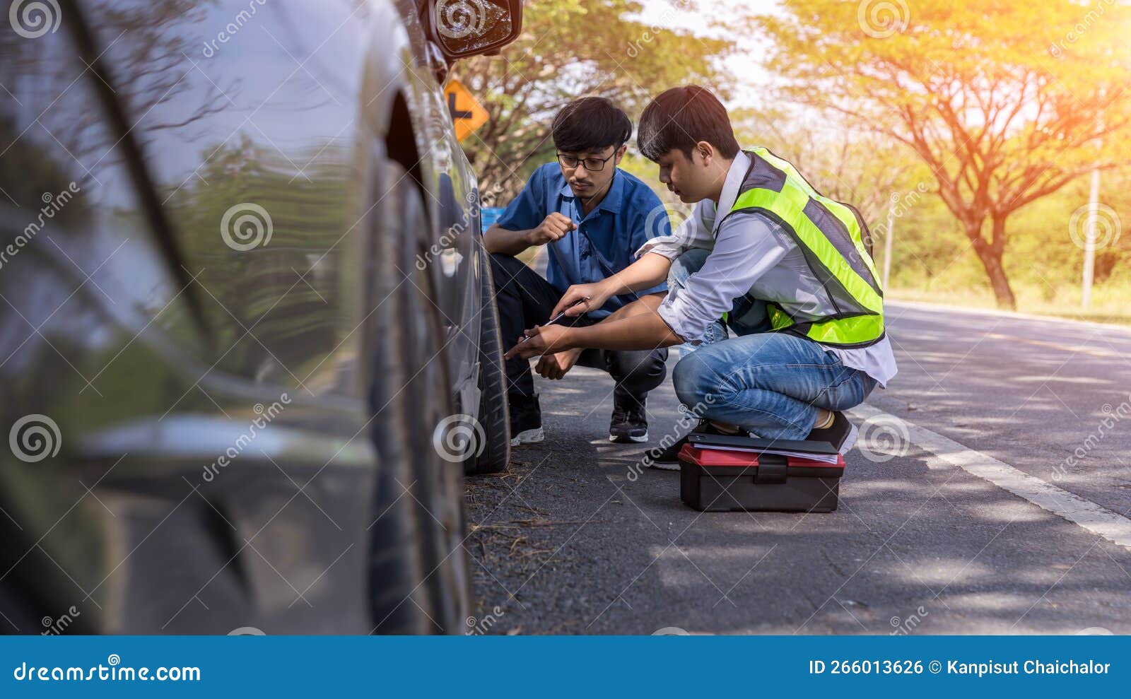 Emergency Roadside Assistance, Technician Helps with Wheel Replacement ...