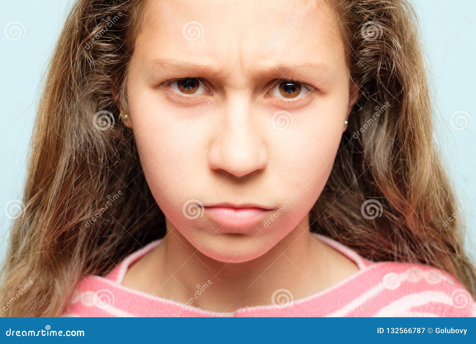 Frowning Grumpy Teen Boy Standing With Folded Arms Over Blue Background ... Frowning Grumpy Teen Boy Standing With Folded Arms Over Blue Background ...