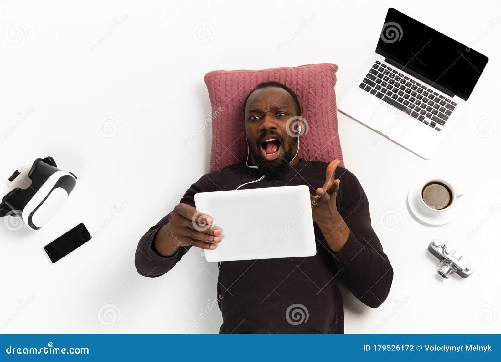 Emotional African-american Man Using Tablet Surrounded by Gadgets ...
