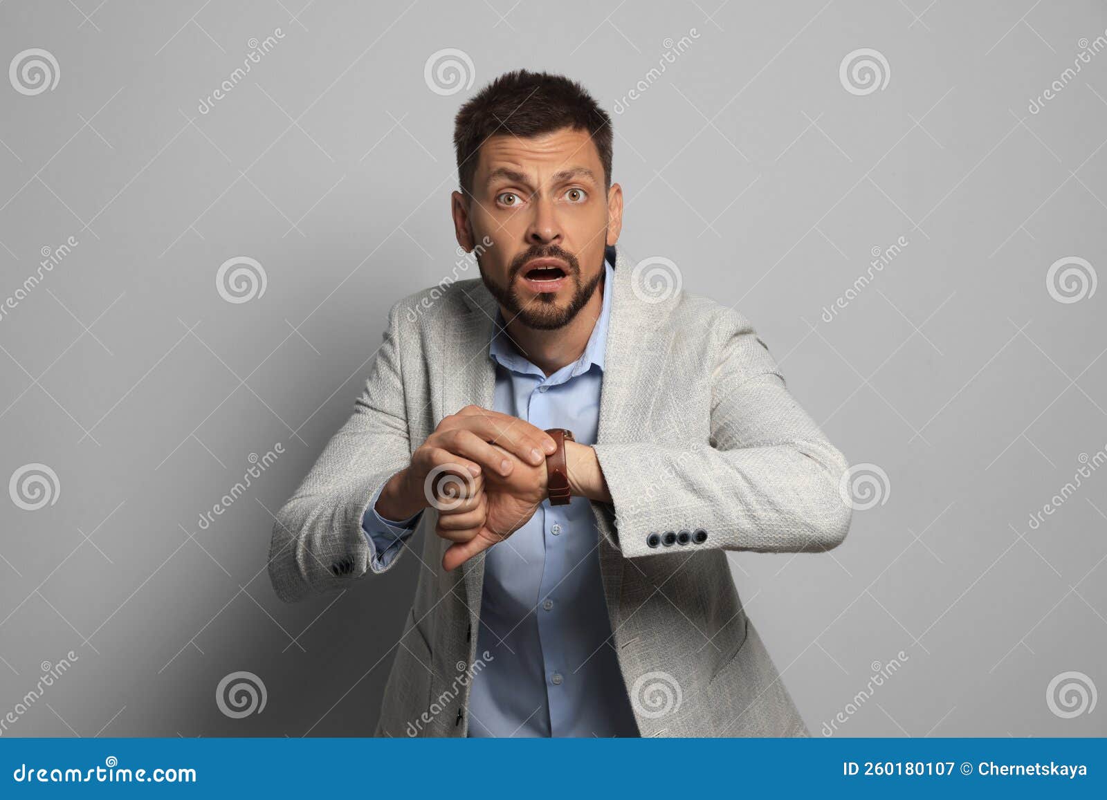 Emotional Man Checking Time on Grey Background. Being Late Concept ...