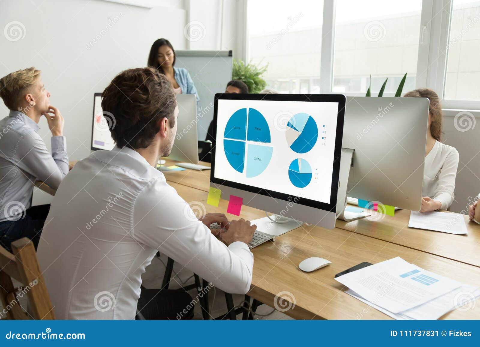 Employee Analyzing Computer Statistics Working in Office with Mu Stock ...