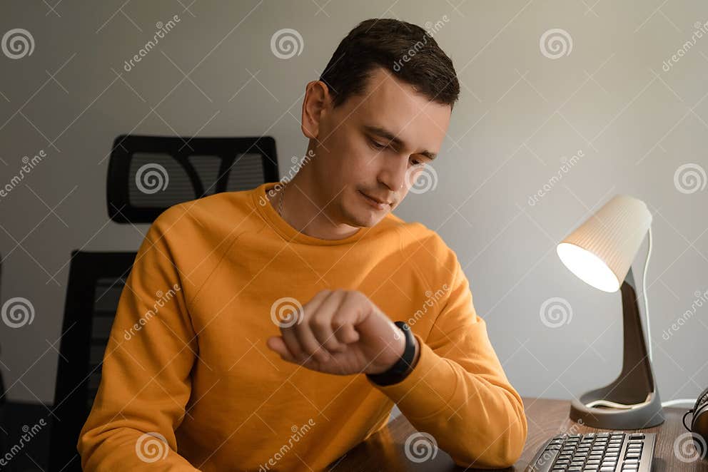 An Employee is Checking How Much Time is Left To Complete the Task ...