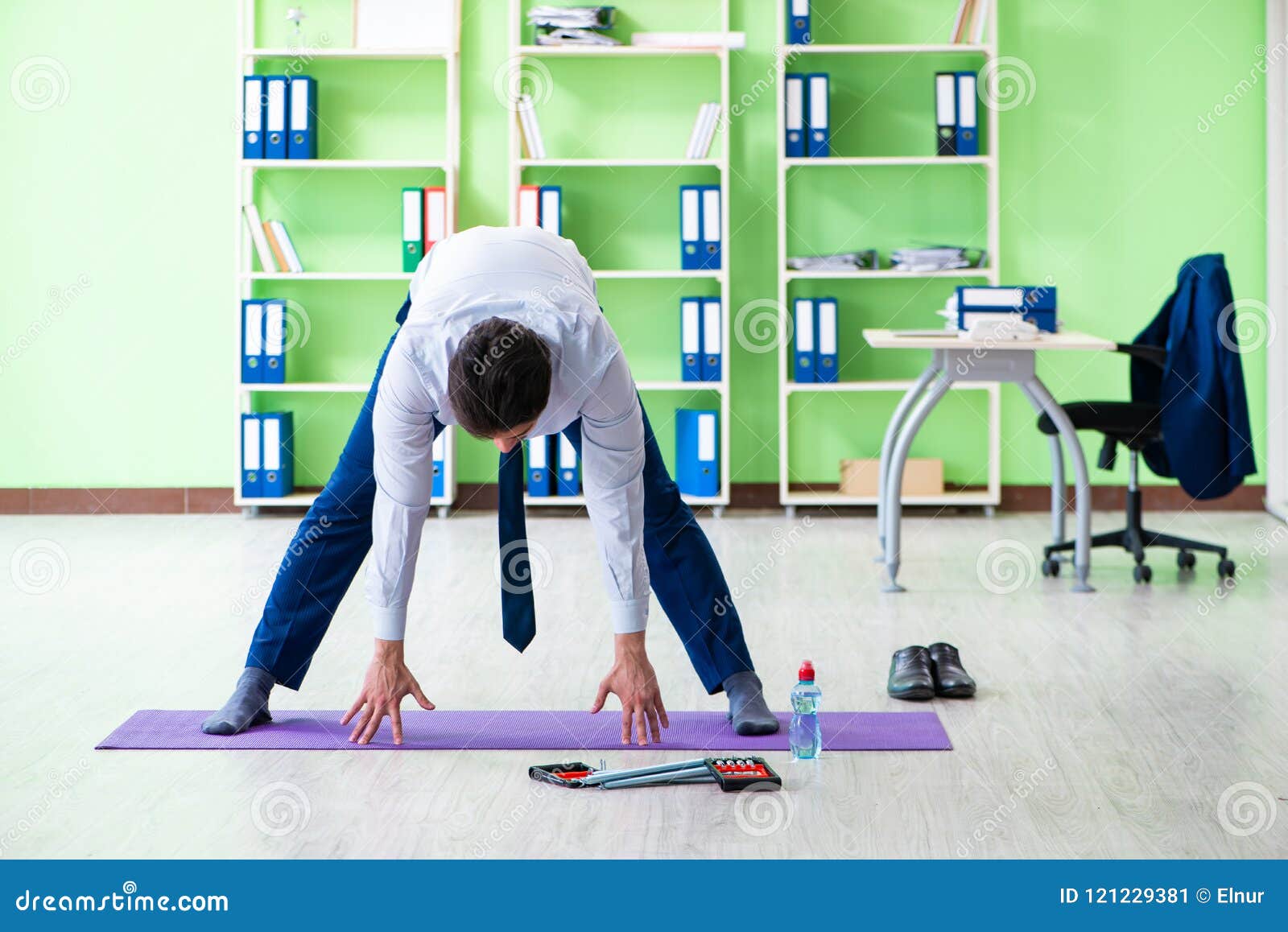 The Employee Doing Exercises during Break at Work Stock Image - Image ...