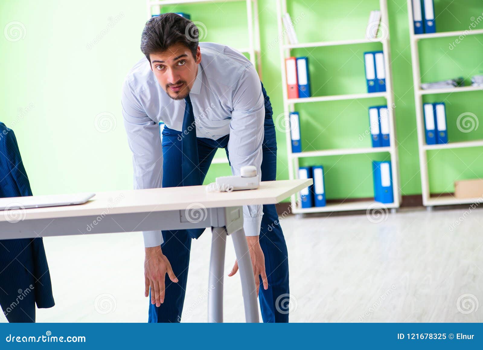 The Employee Doing Exercises during Break at Work Stock Image - Image ...