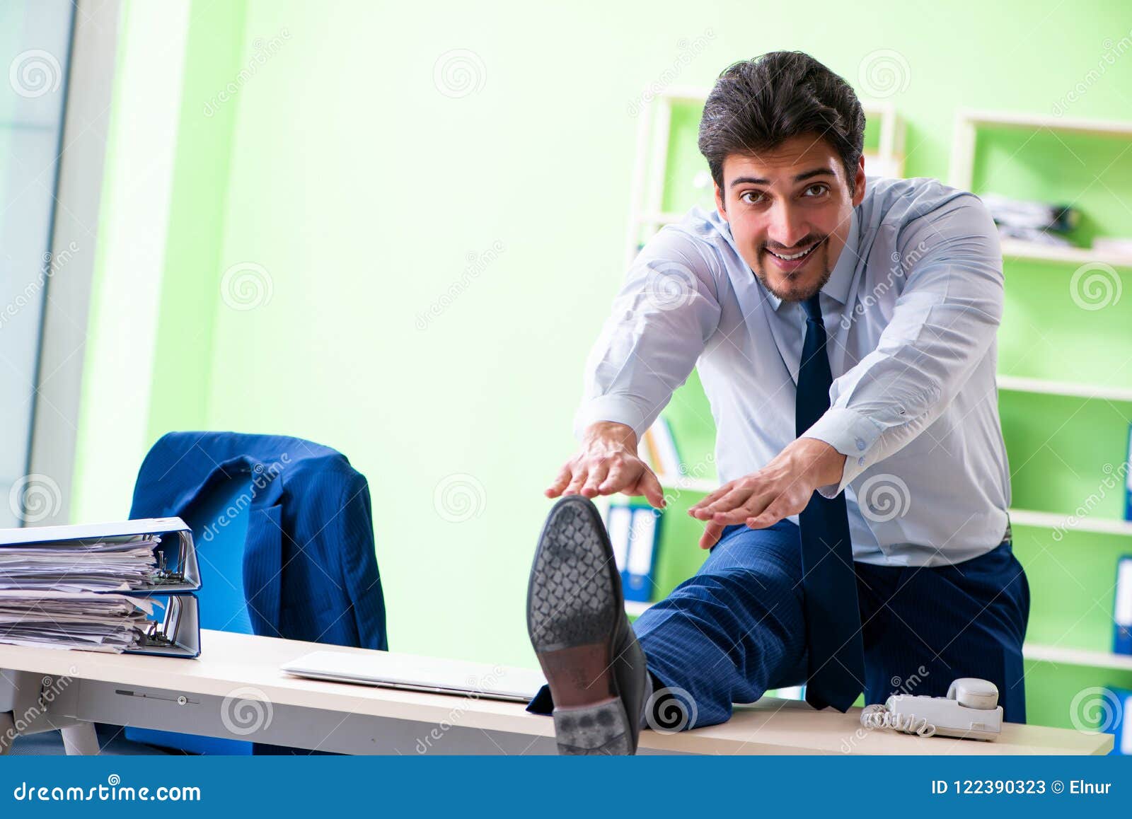 The Employee Doing Exercises during Break at Work Stock Image - Image ...