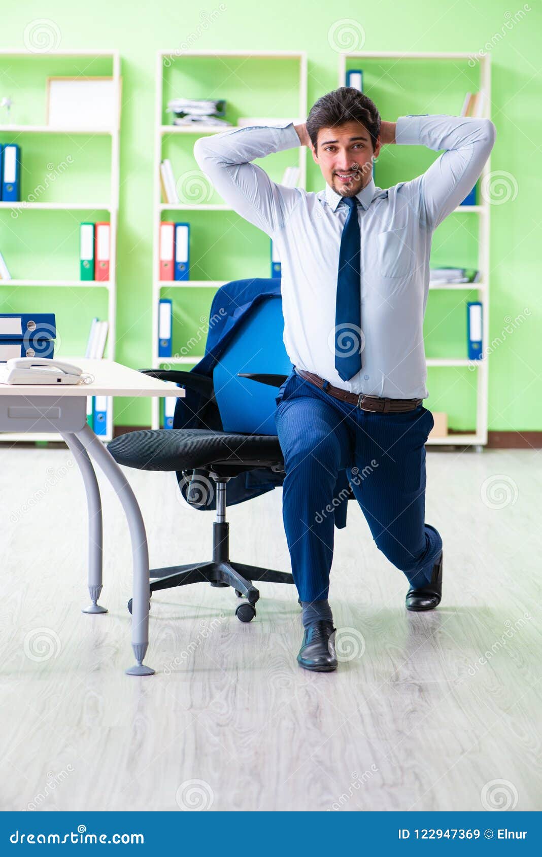 The Employee Doing Exercises during Break at Work Stock Image - Image ...
