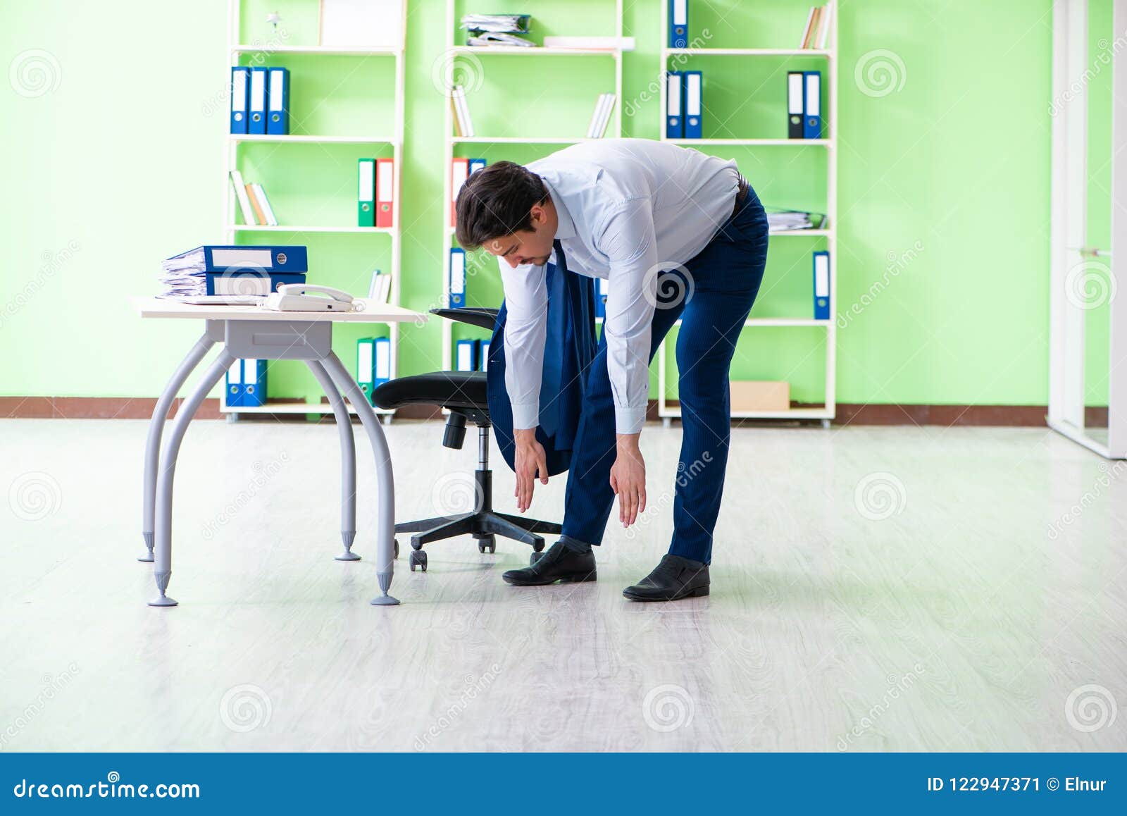 The Employee Doing Exercises during Break at Work Stock Image - Image ...