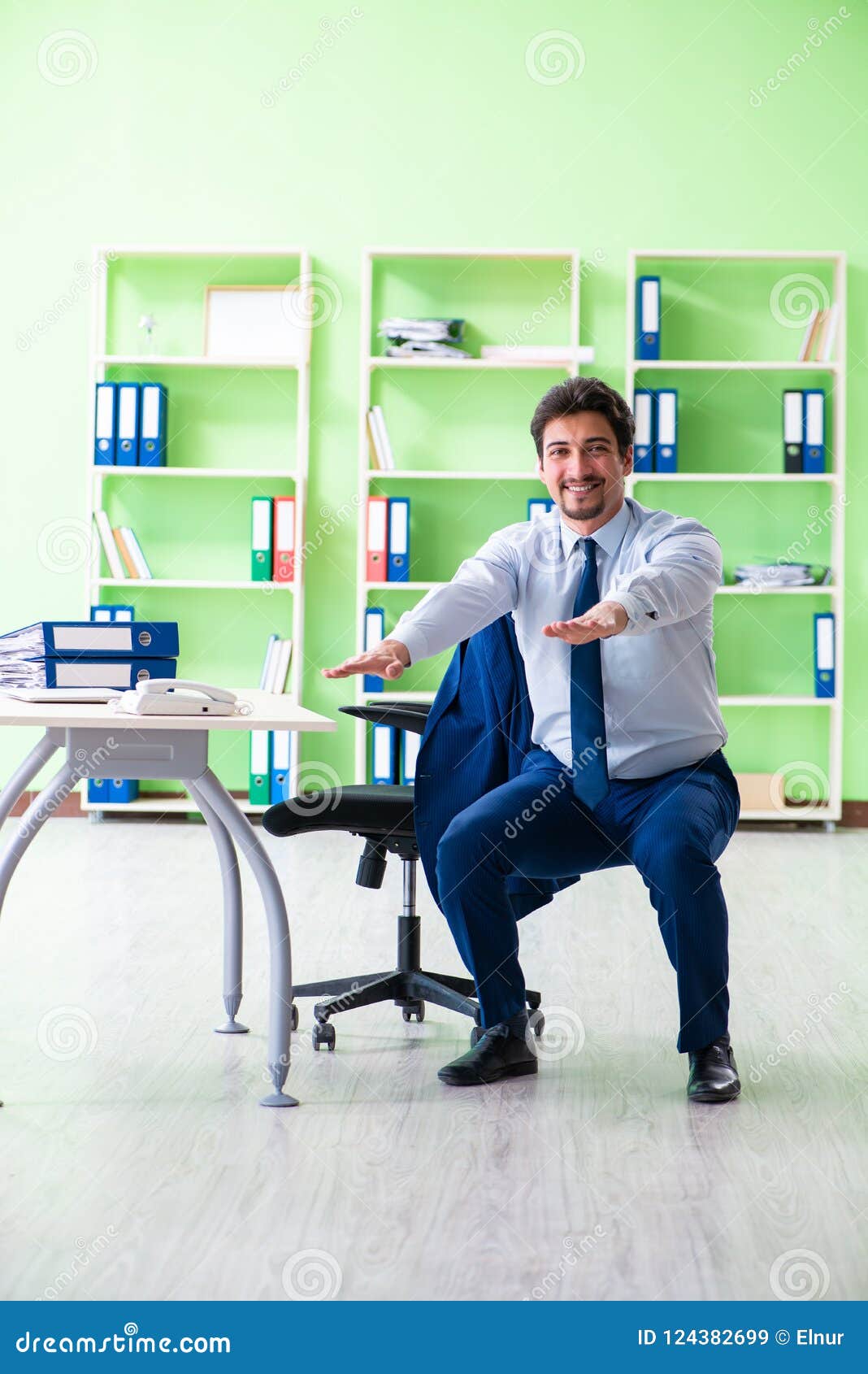 The Employee Doing Exercises during Break at Work Stock Image - Image ...