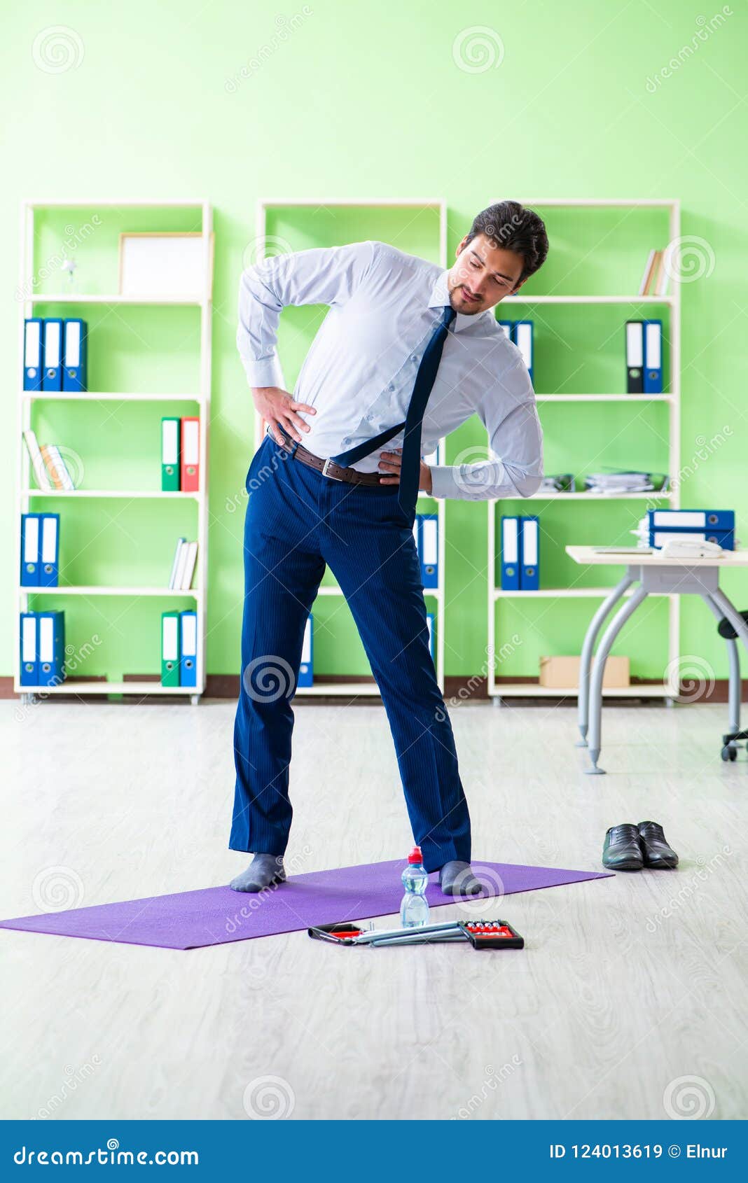The Employee Doing Exercises during Break at Work Stock Image - Image ...