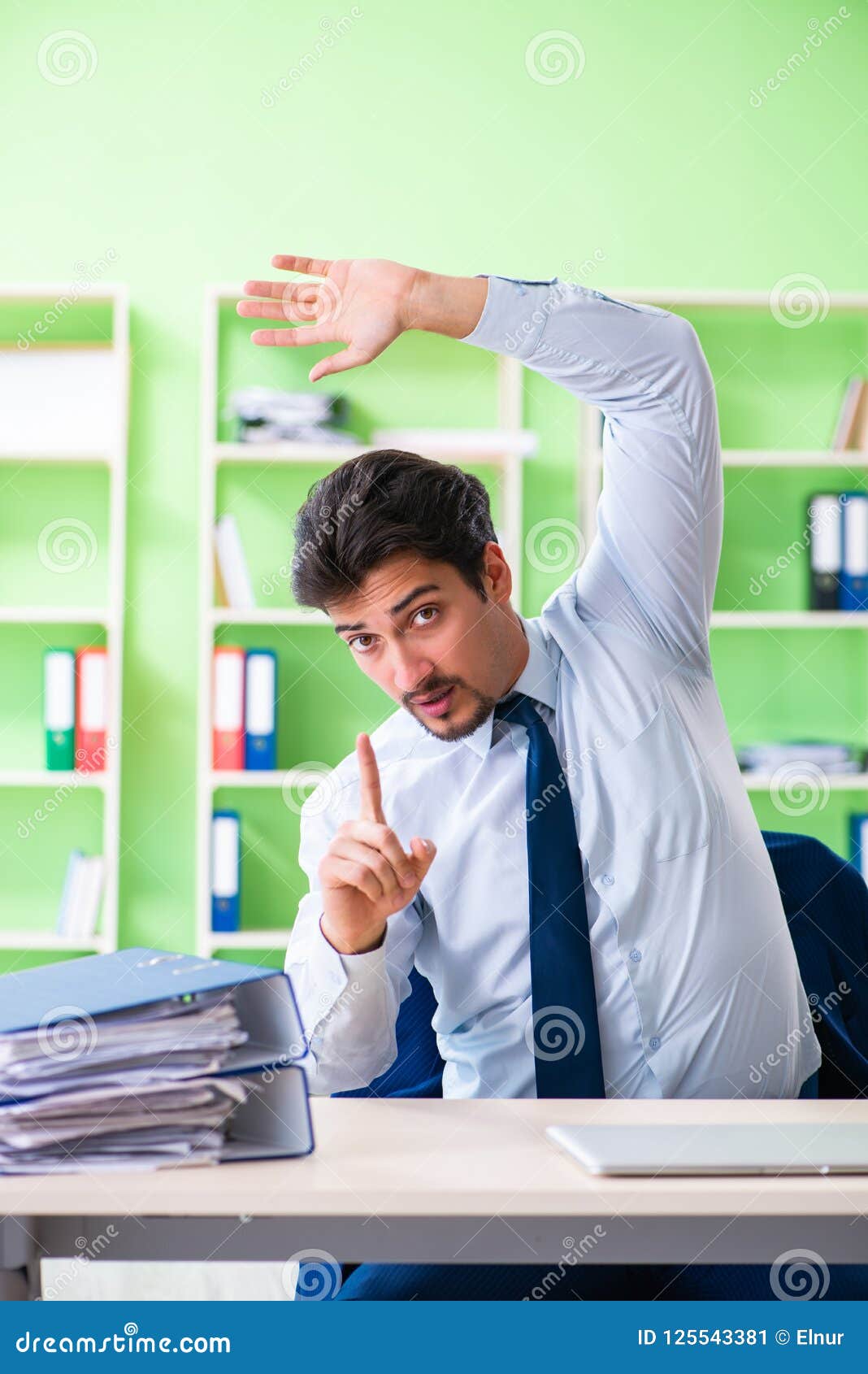 The Employee Doing Exercises during Break at Work Stock Image - Image ...