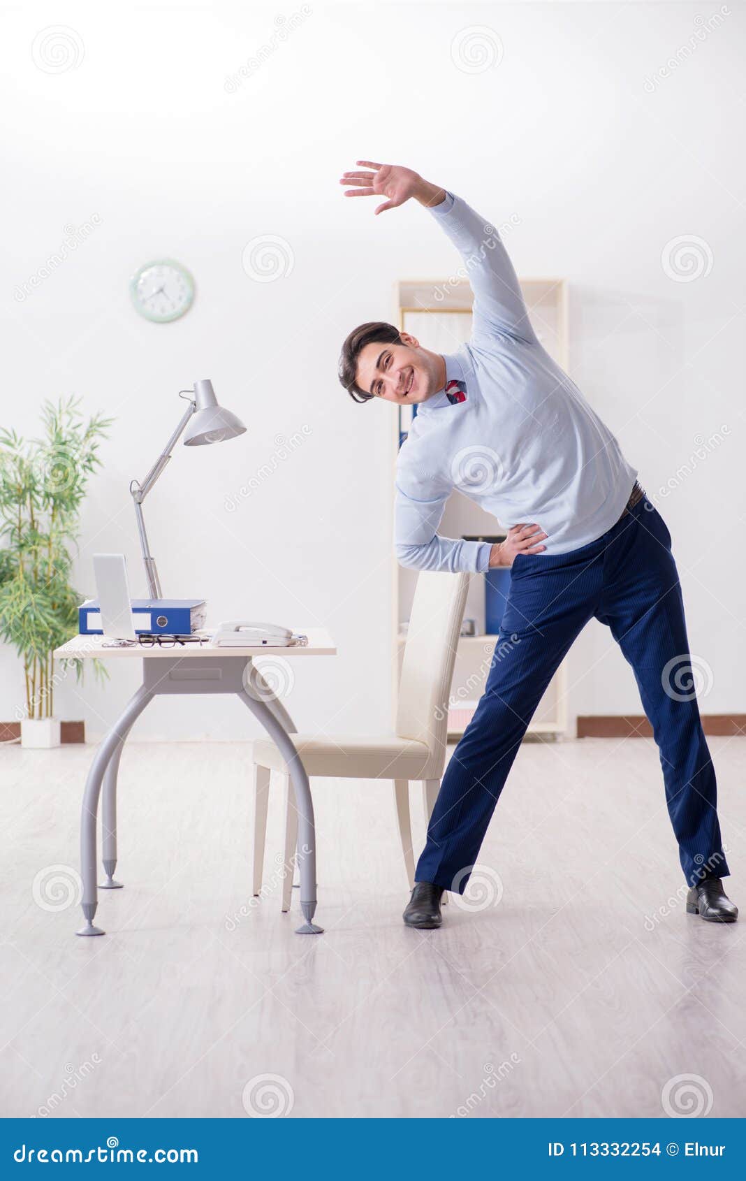 The Employee Doing Stretching Exercises in the Office Stock Photo ...