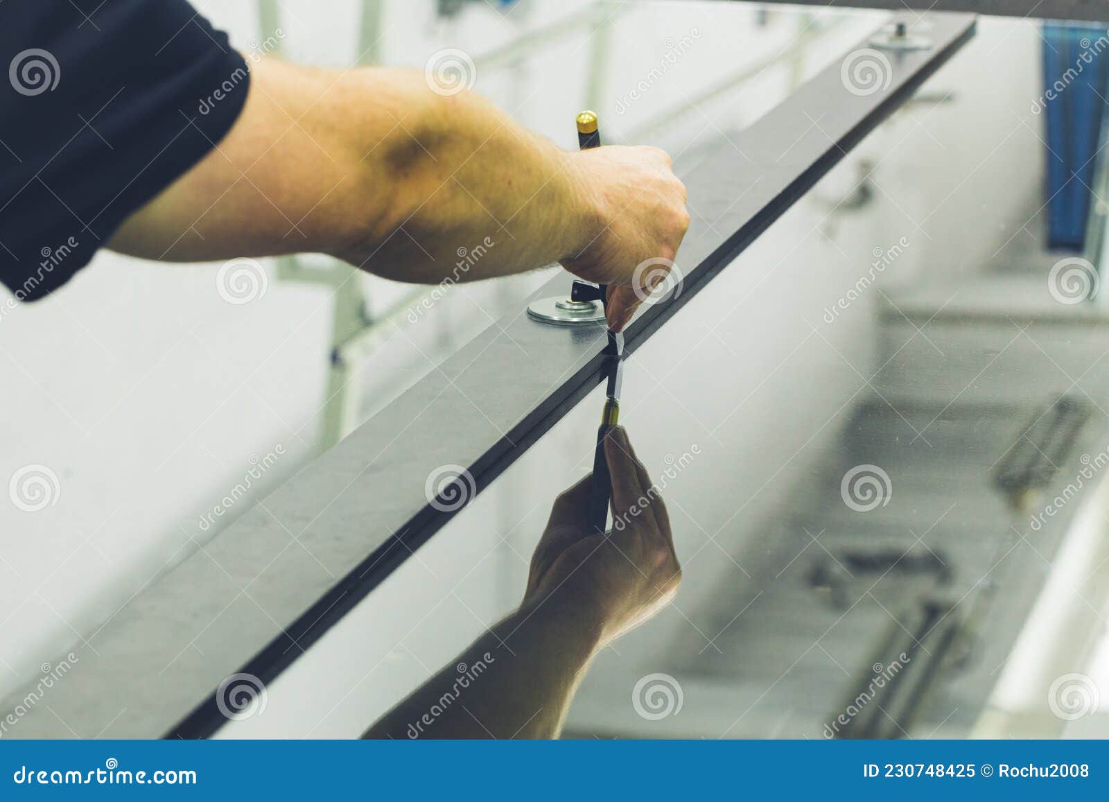 An Employee in a Glass Factory Cuts a Large Sheet of Glass with the ...