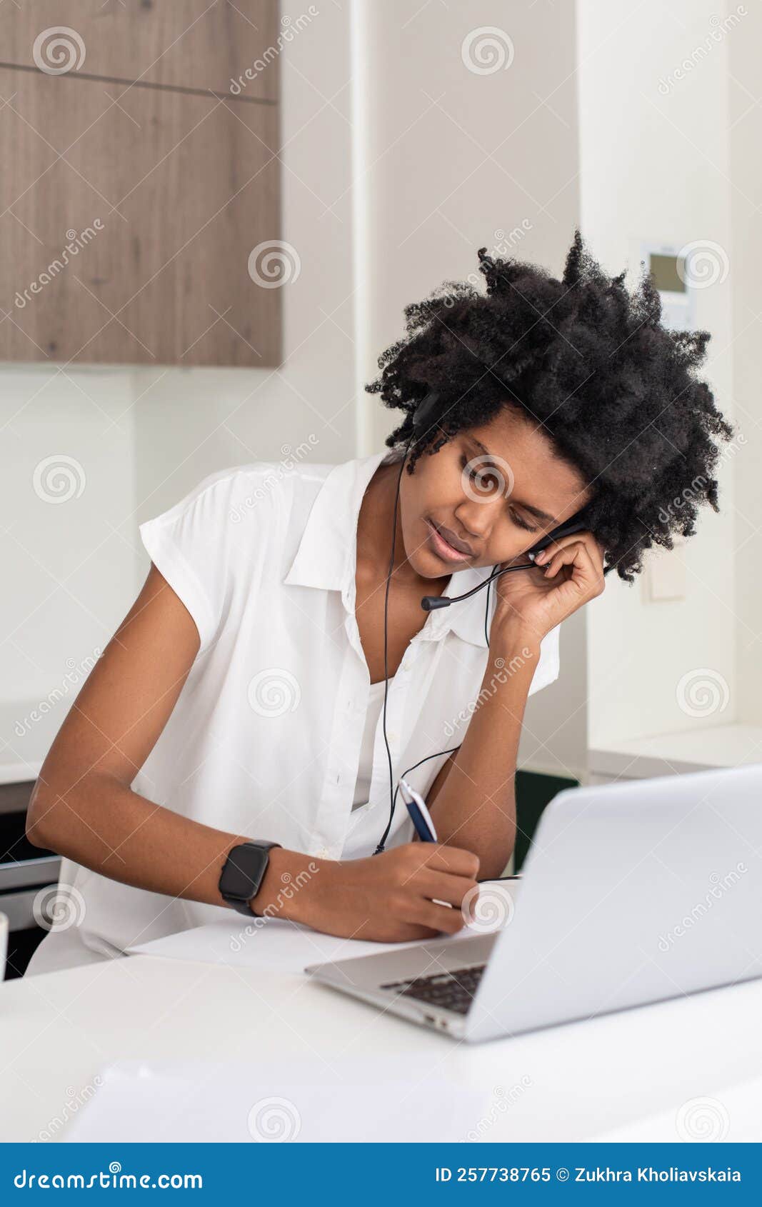 Employee with Headset Talking and Writing Notes Stock Image - Image of ...