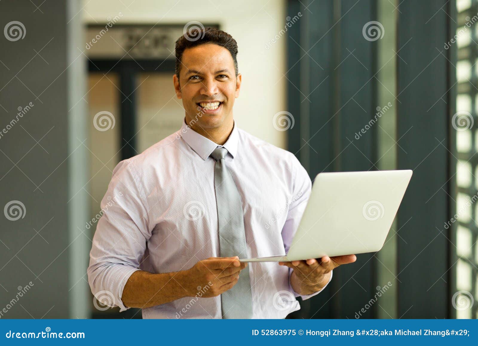 Employee holding laptop stock image. Image of middle - 52863975