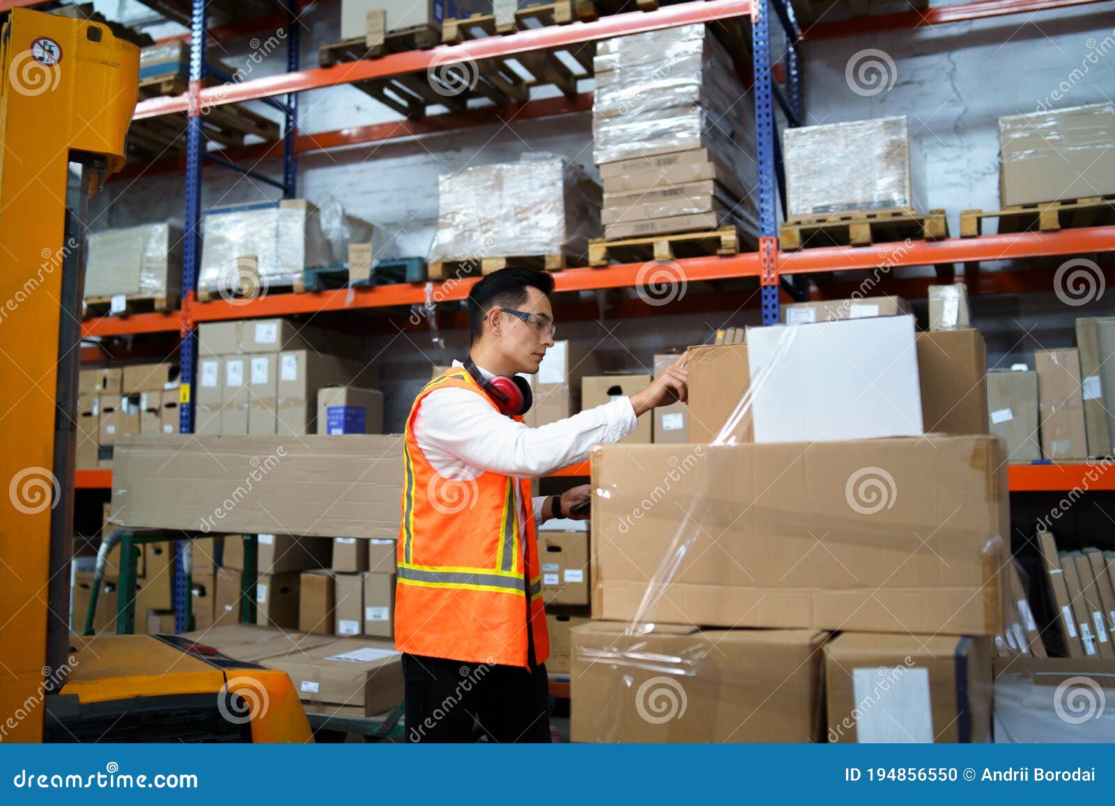 Employee Of A Logistics Warehouse Takes An Inventory Of Goods. Stock ...